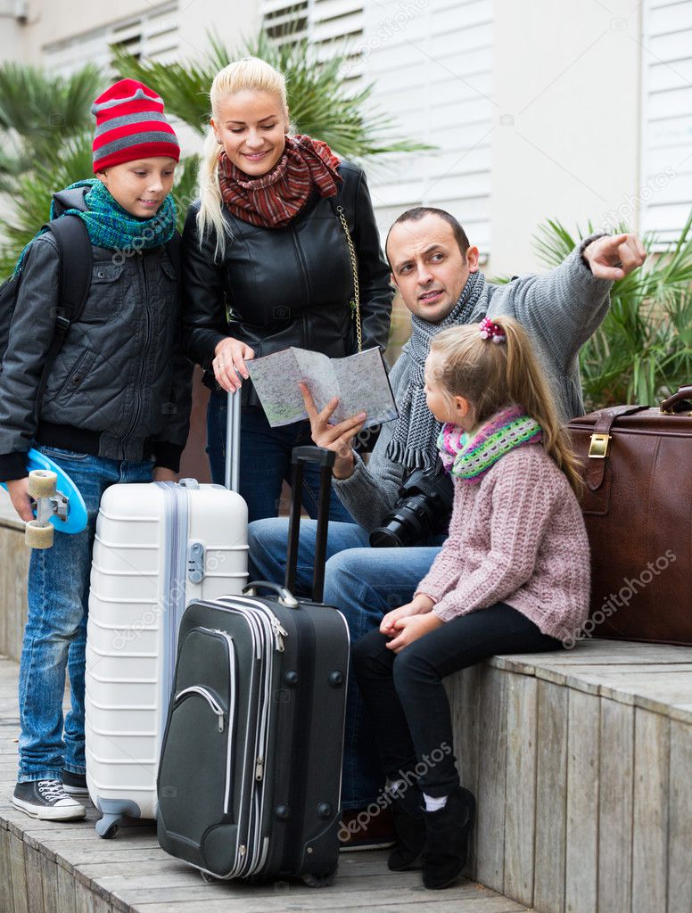 Family checking direction in map Stock Photo by ©Jim_Filim 98764688