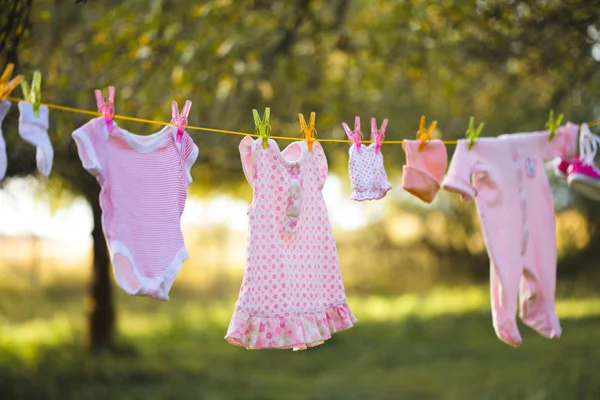 Baby clothes hanging Stock Photos, Royalty Free Baby clothes hanging ...