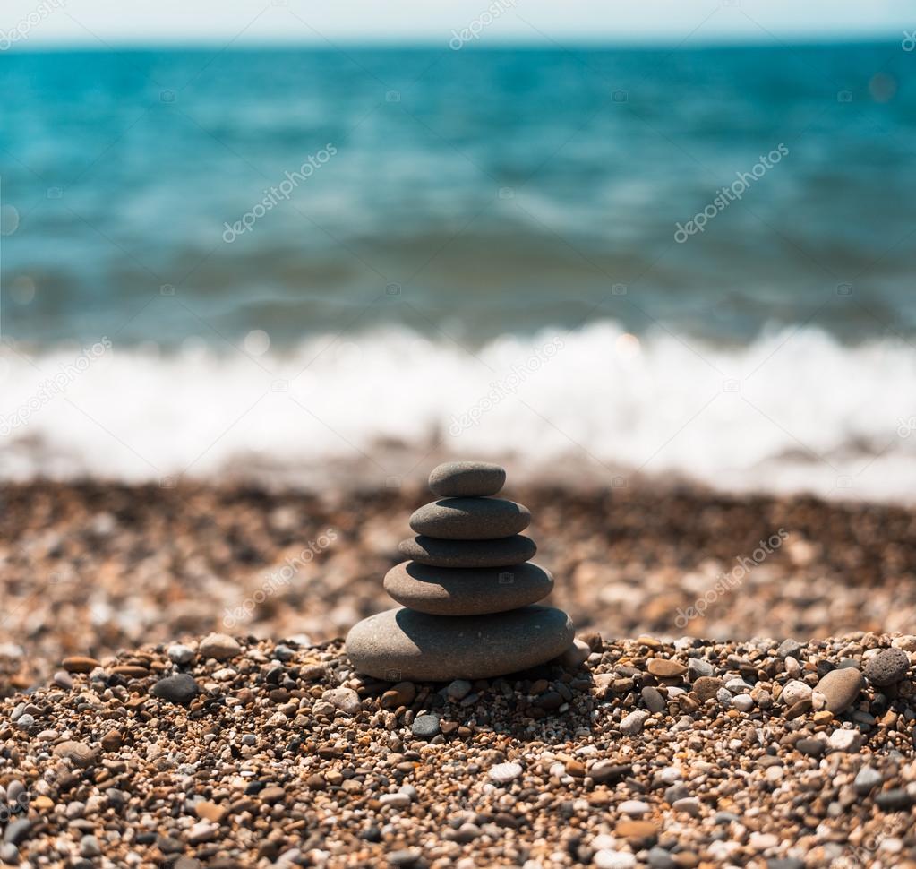 Stack of round smooth stones on a seashore — Stock Photo © ishmel #83383072
