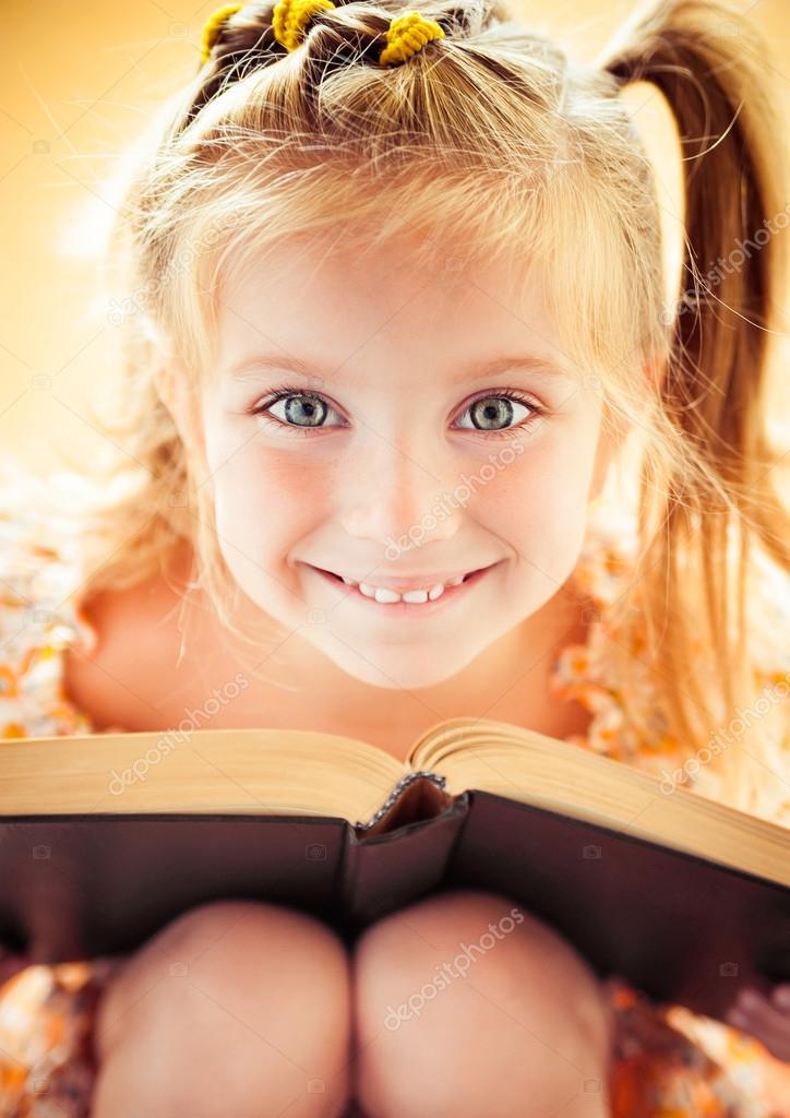 Little girl reading book Stock Photo by ©tan4ikk 71965349