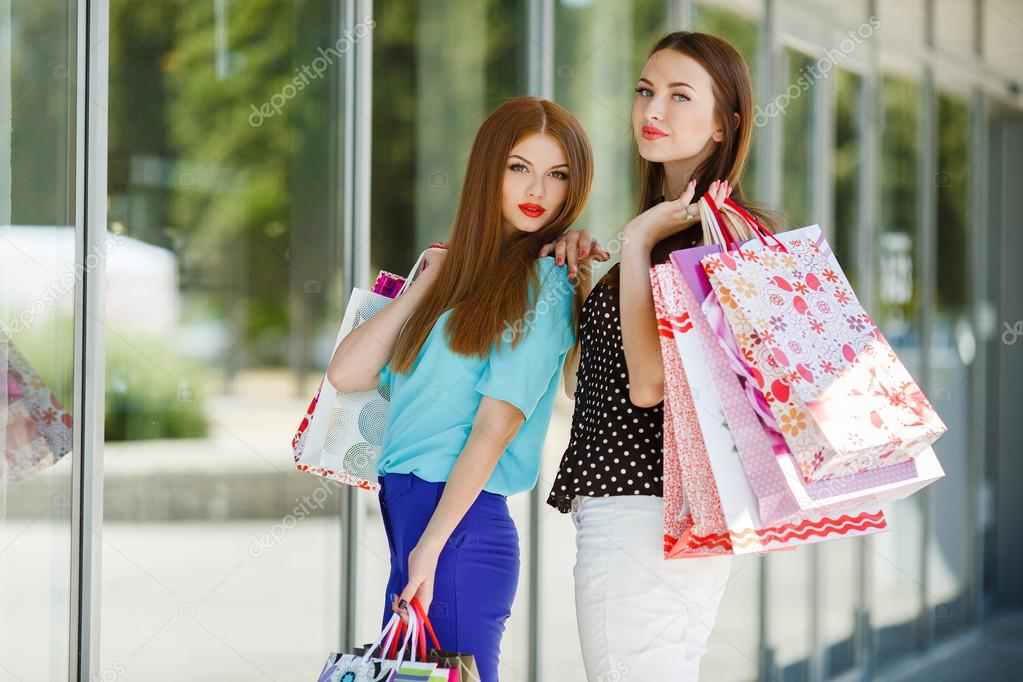 Two cute women view showcases the supermarket. — Stock Photo © golyak ...