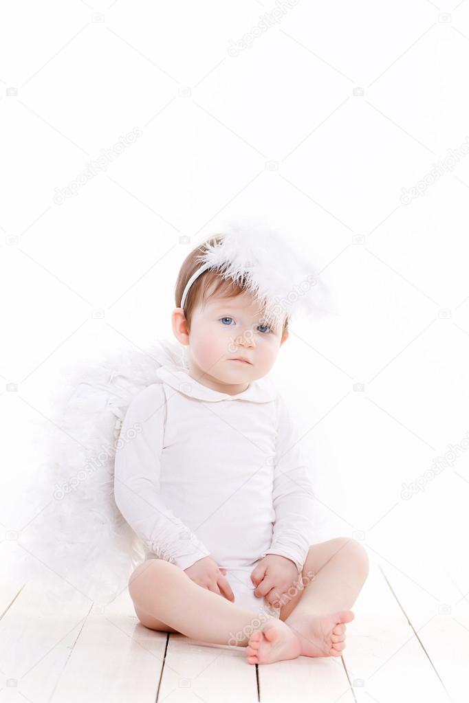 Small angel with the wings isolated on the white. Stock Photo by ...