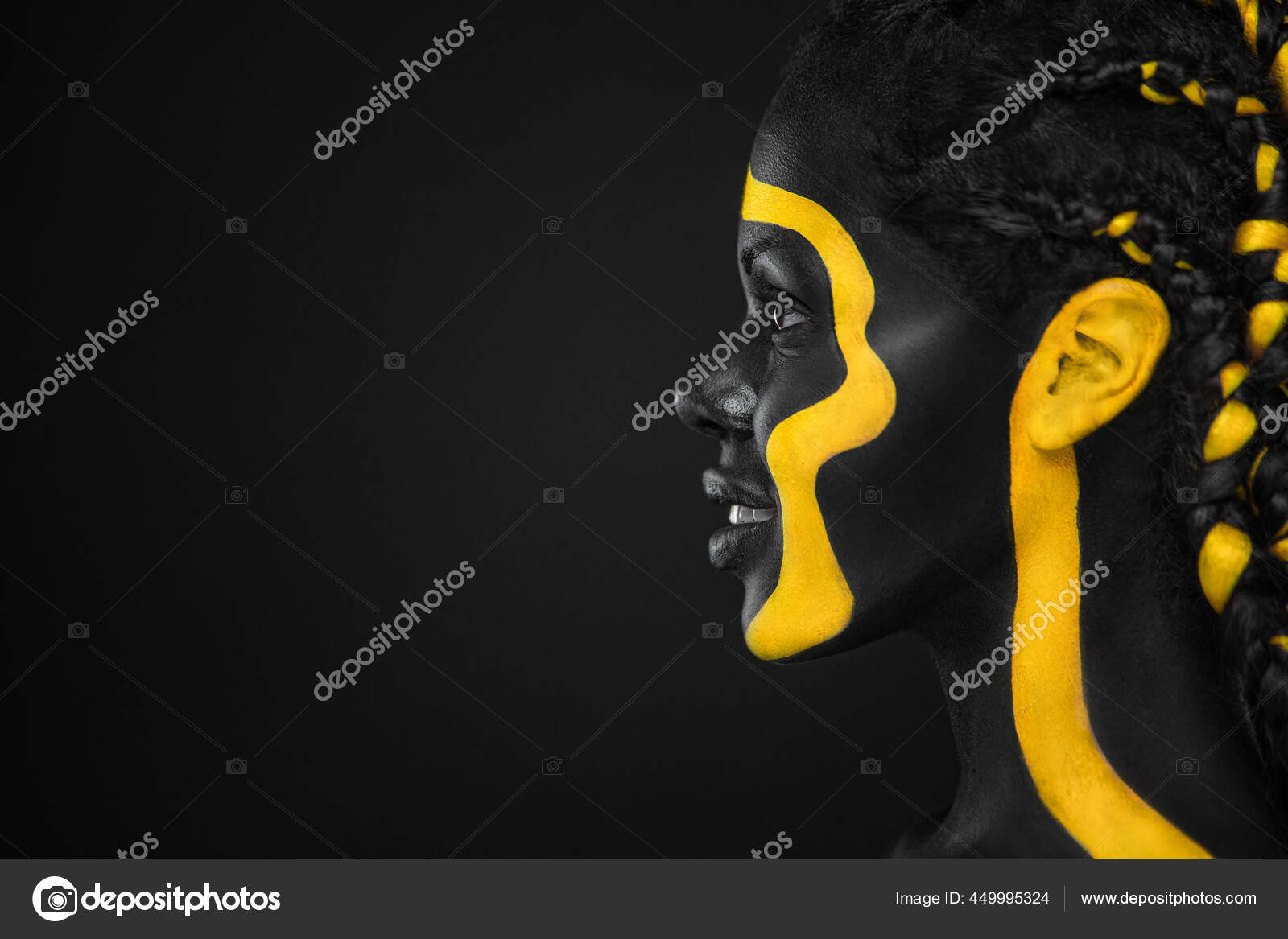 Yellow and black body paint. Woman with face art. Young girl with ...