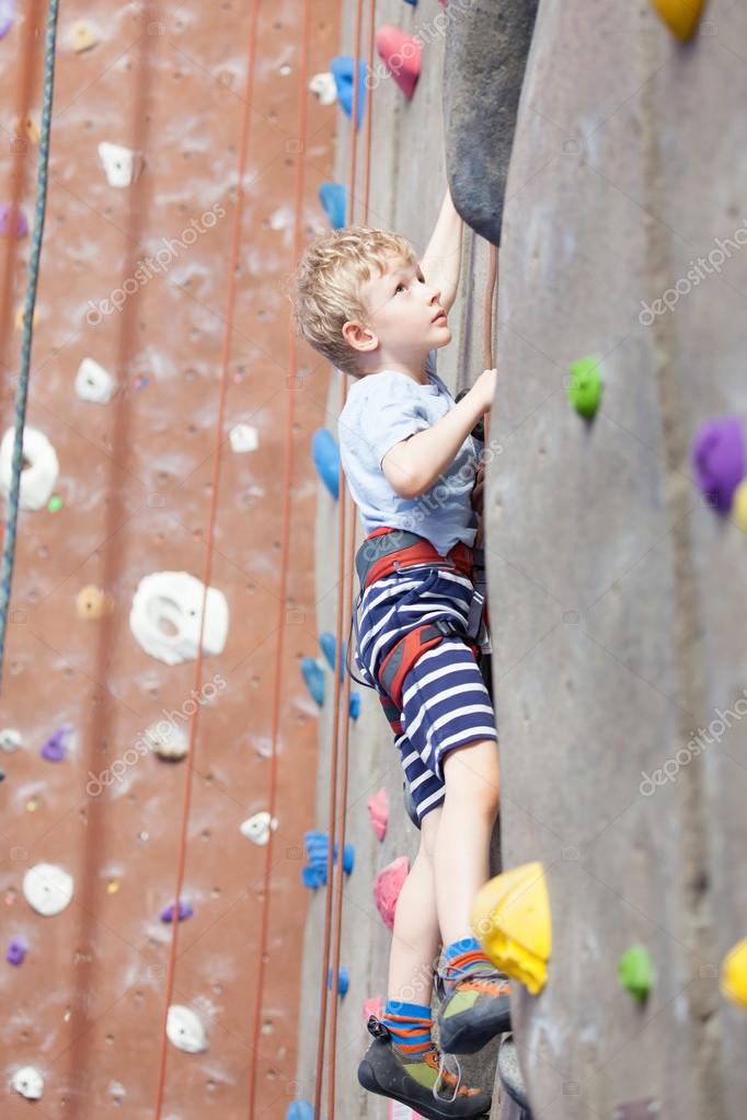 Boy rock climbing ⬇ Stock Photo, Image by © noblige #84318926