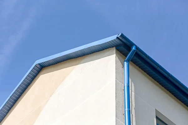 Newly installed blue rain gutter and drainpipe — Stock Photo ...