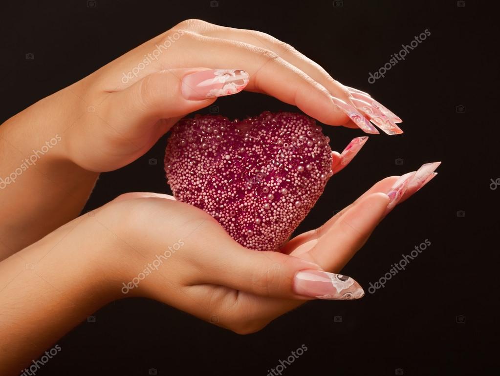 Human hands with beautiful manicure hold pink heart Stock Photo by ...