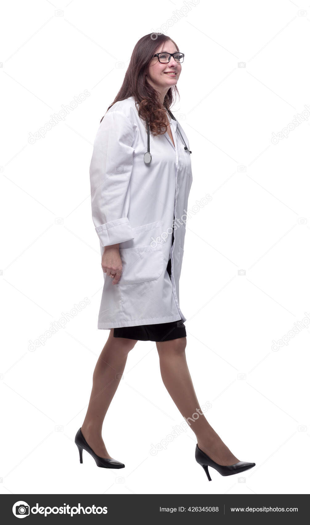 Side view. a smiling woman doctor striding forward Stock Photo by ...