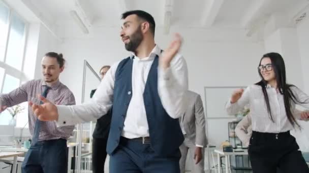 Slow motion portrait of office workers male and female dancing relaxing ...