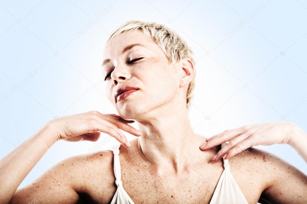 Woman touching her face and shoulder Stock Photo by ©nanka-photo 73308337