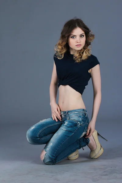 Girl in torn jeans Stock Photo by ©gsdonlin 70537583