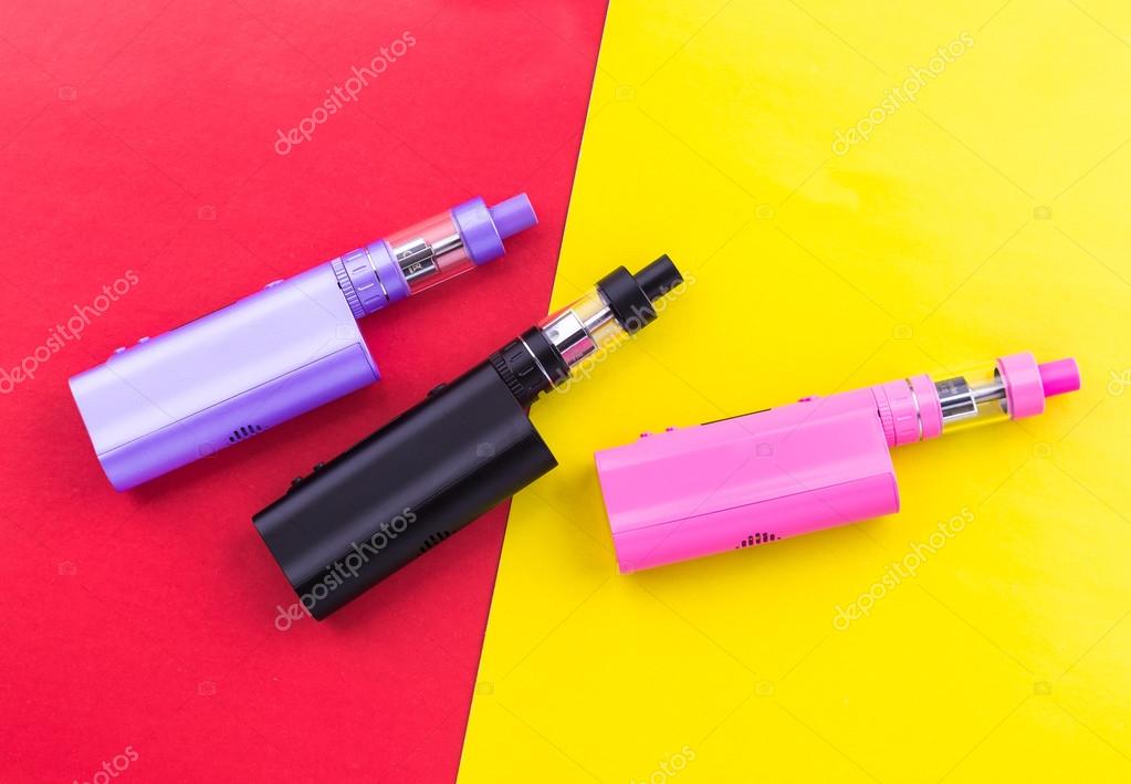 Vaping devices color background Stock Photo by ©gilmanshin 122530940