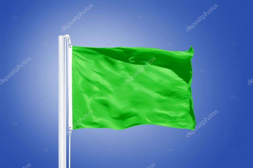 Green flag flying against clear blue sky — Stock Photo © gilmanshin ...
