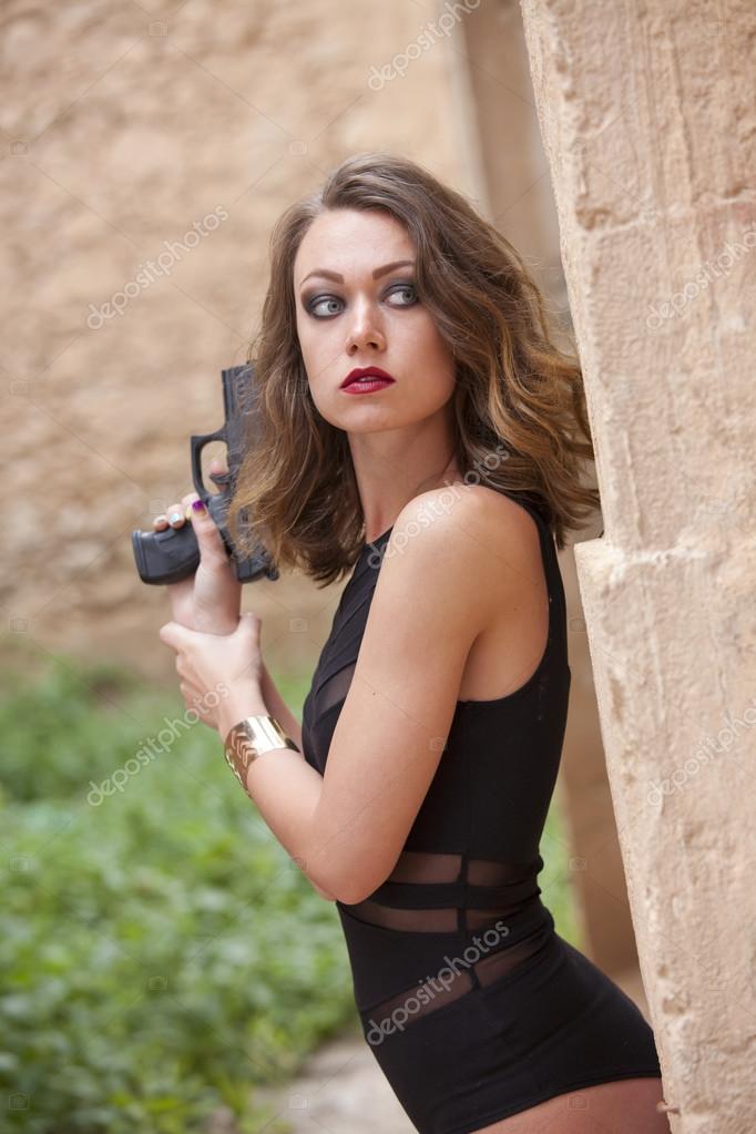 Sexy Spy with gun Stock Photo by ©eddiephotograph 93091472