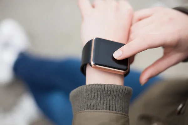Woman using her smart watch on hand - Stock Image - Everypixel