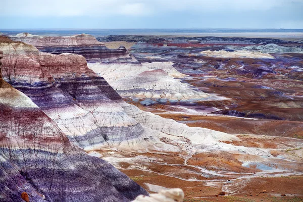 Striped purple sandstone formations Stock Photo by ©MNStudio 109413124