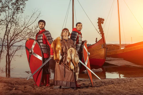 Slavic princess and two warriors with swords and shields on the ...