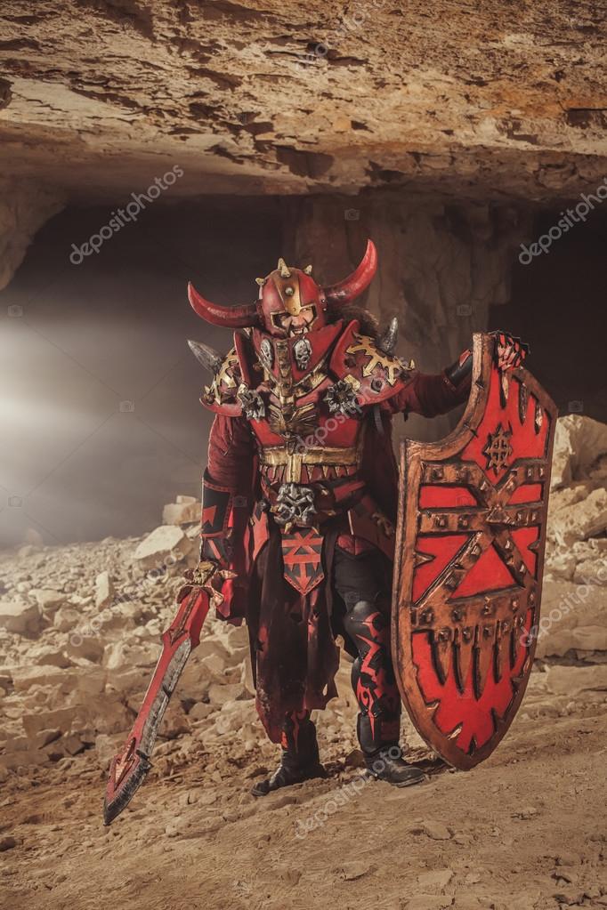 Powerful knight in heavy armor with the sword and shield on the Stock ...