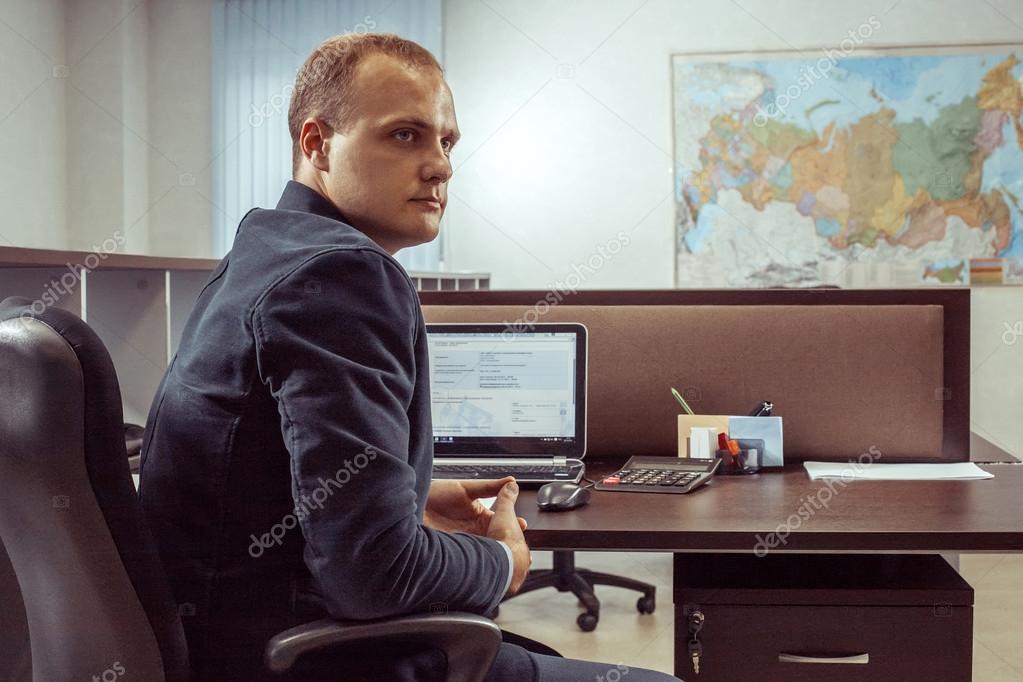 Portrait of the caucasian businessman sitting at the table in of Stock ...