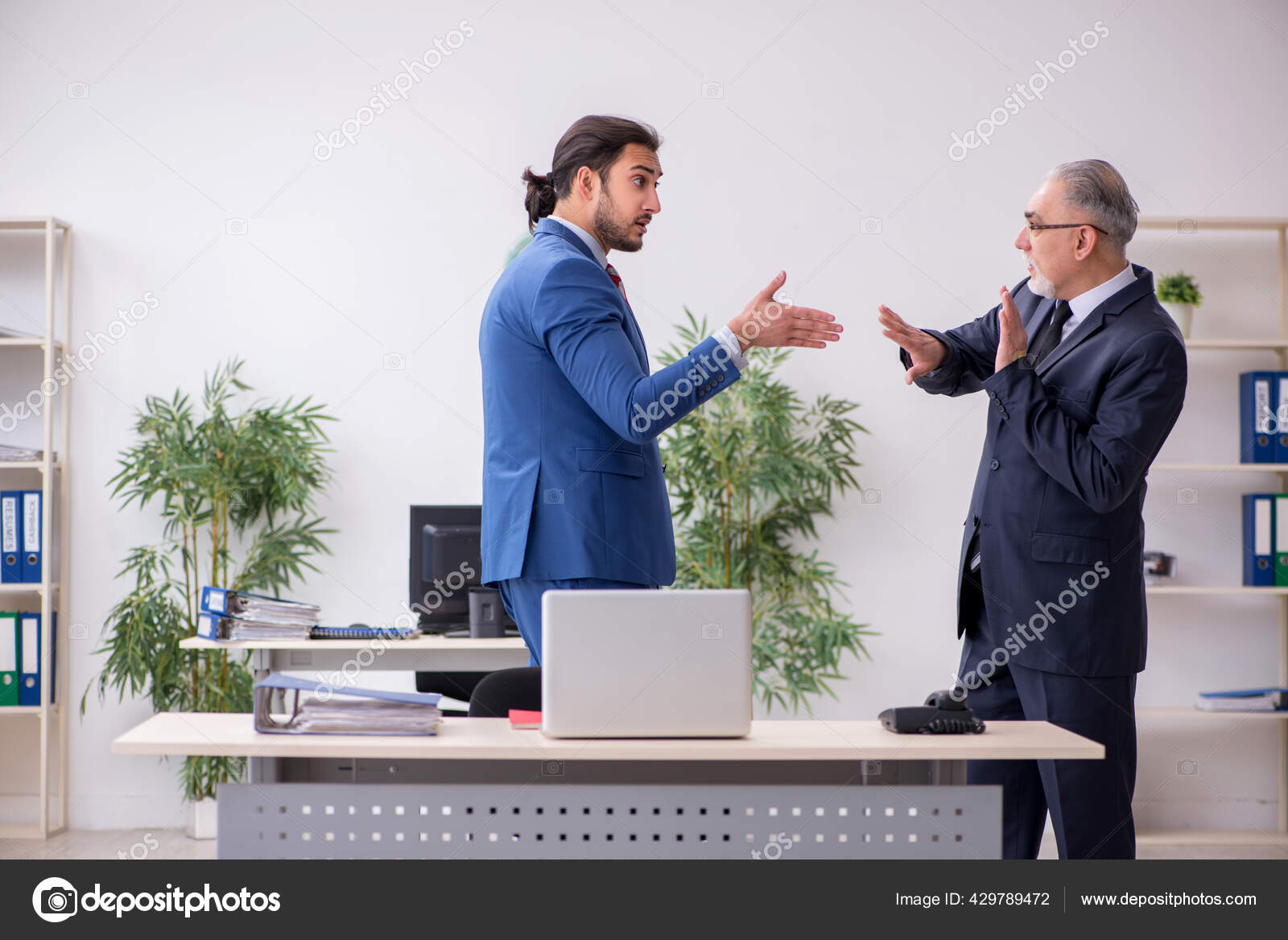 Two employees at workplace during pandemic Stock Photo by ©Elnur_ 429789472