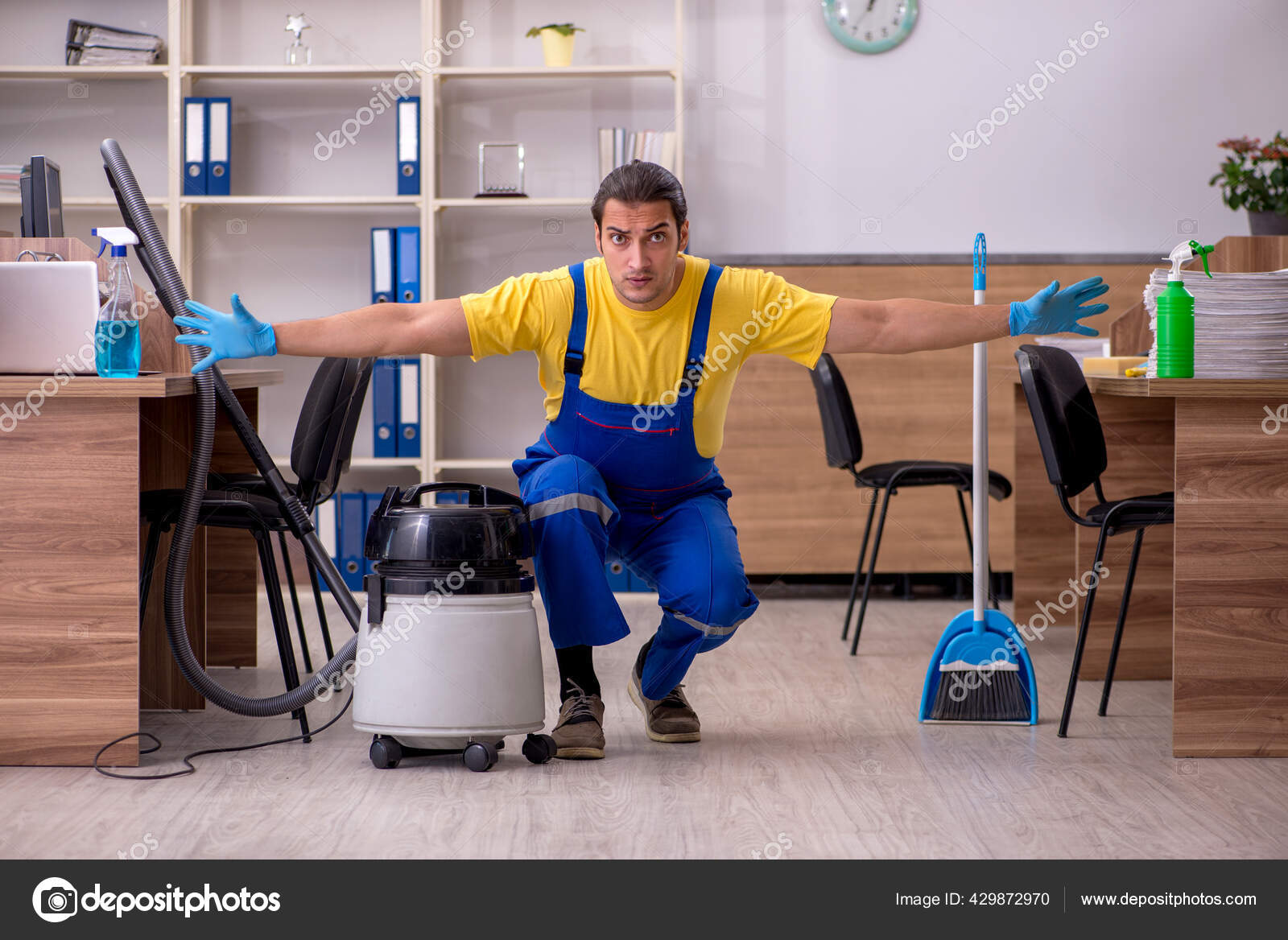 Young male contractor cleaning the office — Stock Photo © Elnur_ #429872970