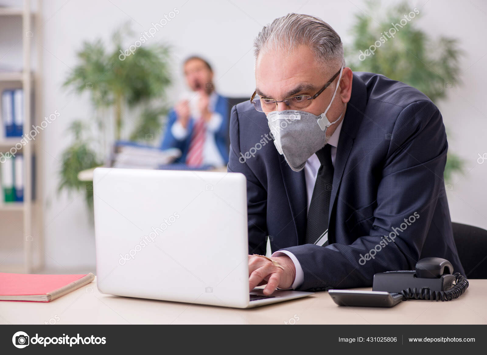 Two employees at workplace during pandemic Stock Photo by ©Elnur_ 431025806