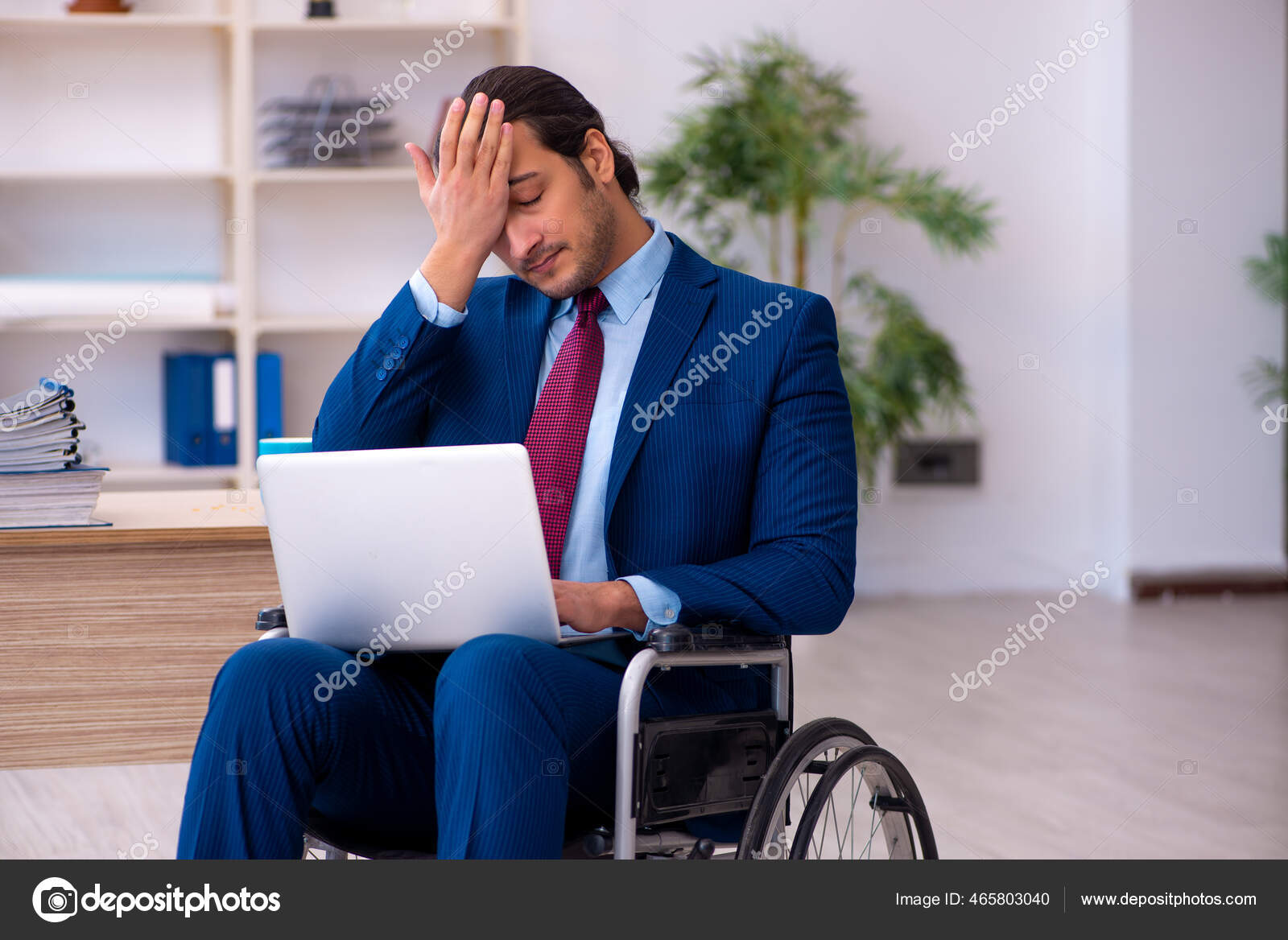 Young disabled employee working in the office — Stock Photo © Elnur ...
