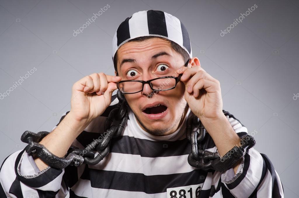 Young prisoner in chains against gray — Stock Photo © Elnur_ #83739652