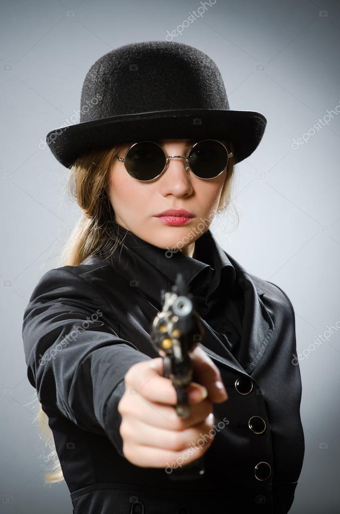 Female spy with weapon against gray Stock Photo by ©Elnur_ 86569460 Female spy with weapon against gray Stock Photo by ©Elnur_ 86569460