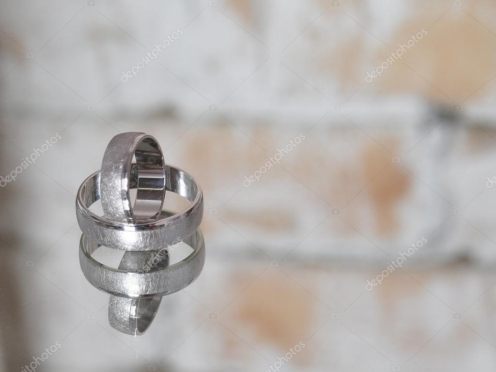 Wedding rings on a reflective surface — Stock Photo © FineShine #106845272