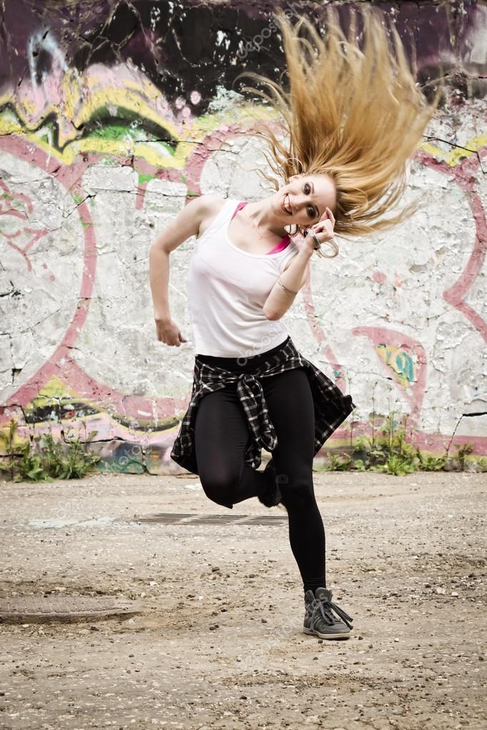 Young girl dancing on graffiti background Stock Photo by ©Demian 82903484