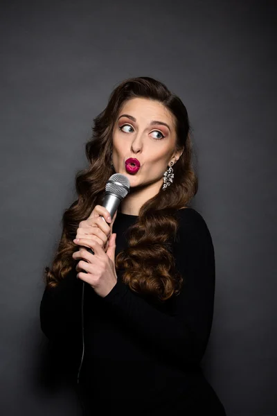 Beautiful lady singing in studio Stock Photo by ©svyatoslavlipik 116781960