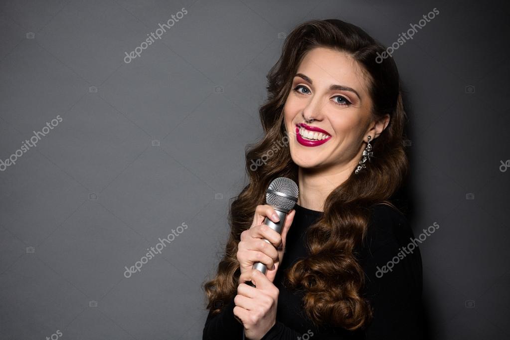 Beautiful lady singing in studio Stock Photo by ©svyatoslavlipik 116781960