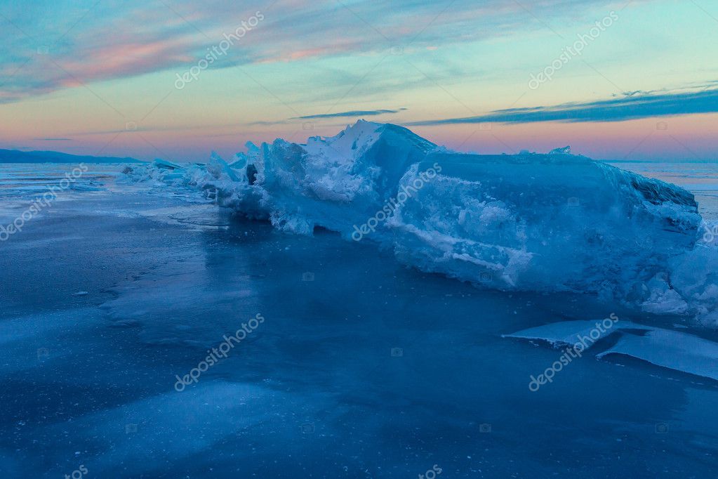 Huge blocks of ice at sunset sky background. — Stock Photo © yykkaa ...