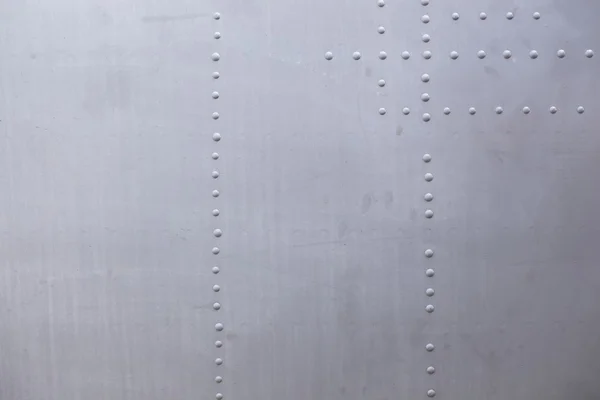 Riveted metal surface — Stock Photo © MADDRAT #51877979