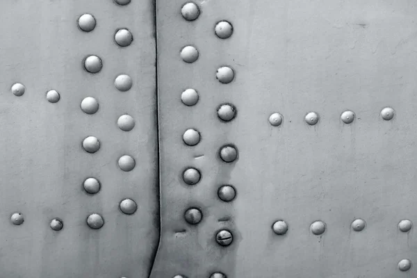 Riveted metal surface — Stock Photo © MADDRAT #51877979