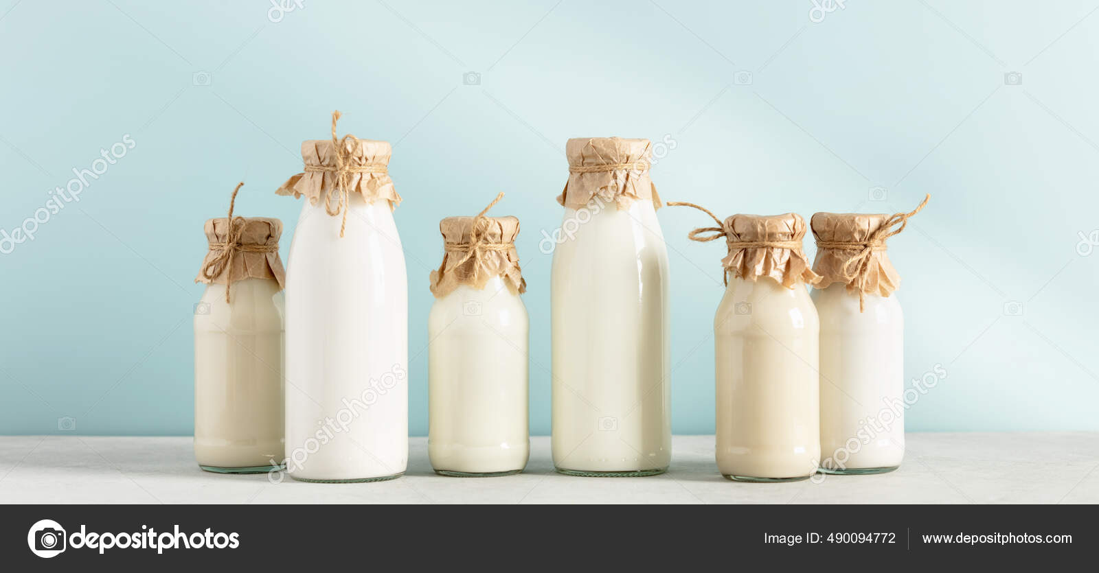 Vegan non dairy plant based milk in bottles on blue background ...