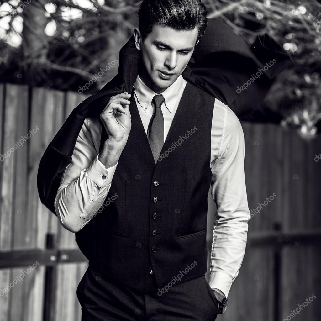 Elegant handsome man in classical suit poses near wooden fence — Stock ...