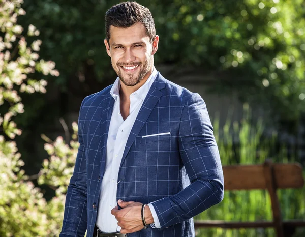 Elegant handsome man in classical jacket poses outdoor Stock Photo by ...