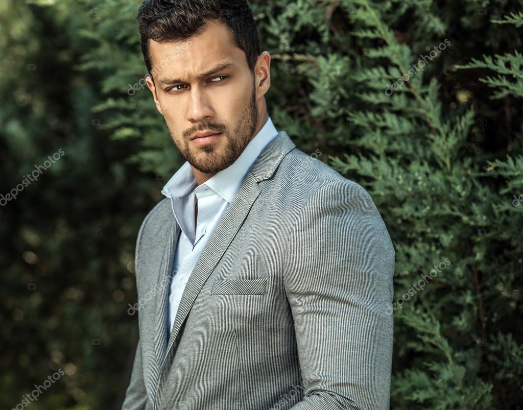 Elegant handsome man in classical jacket poses outdoor Stock Photo by ...