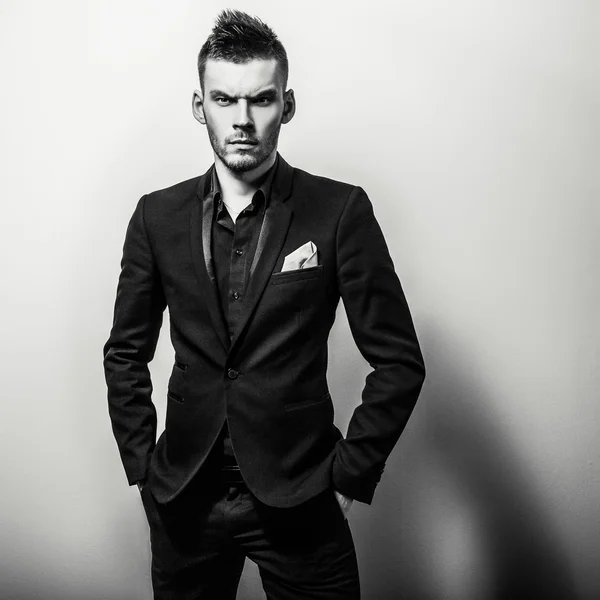 Elegant young handsome serious man in classic costume. Black-white ...