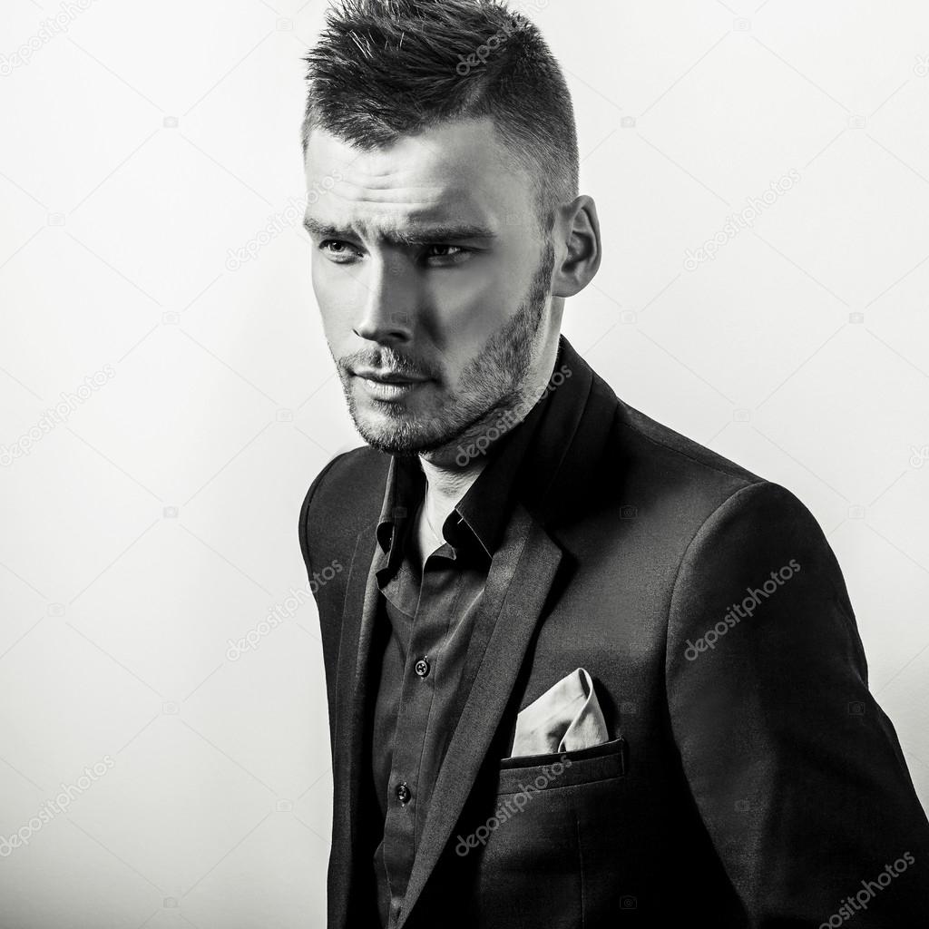 Elegant young handsome serious man in classic costume. Black-white ...