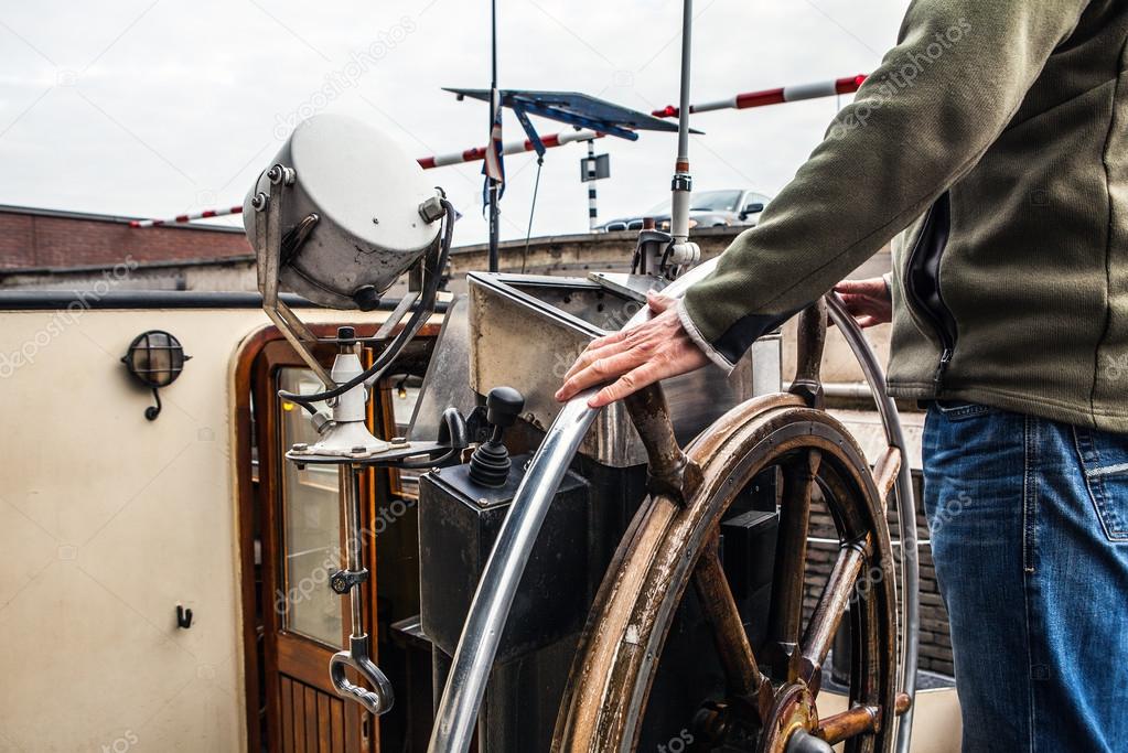 Captain operate an ancient ship Stock Photo by ©innervision 90849642