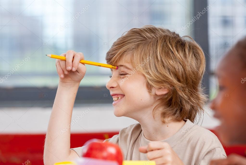 Boy at school with pencil Stock Photo by ©jovannig 74207755