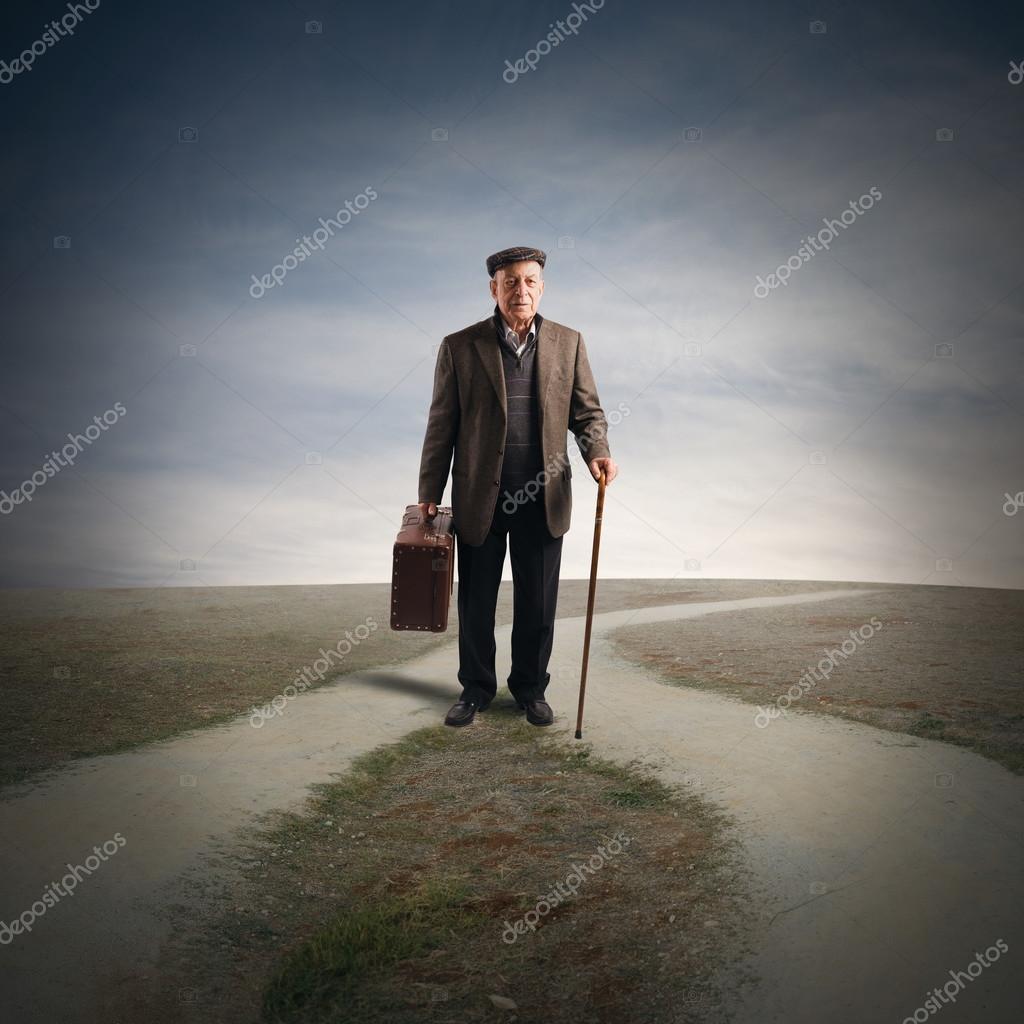 Elderly man at a crossroads Stock Photo by ©alphaspirit 100651010