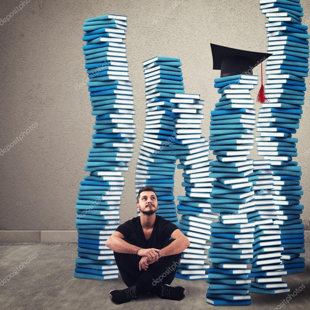 Boy sitting between books Stock Photo by ©alphaspirit 98231460