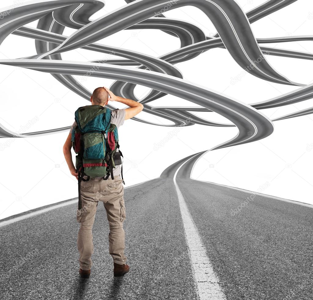 Explorer man before a winding road Stock Photo by ©alphaspirit 99018298