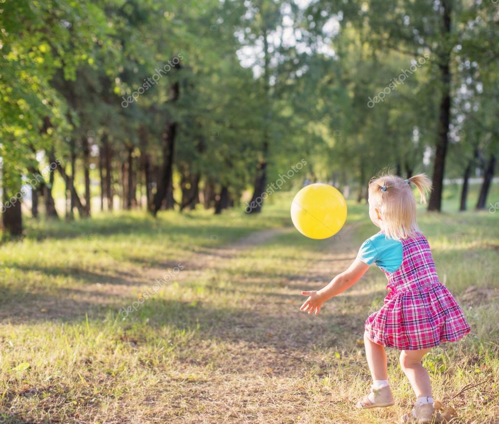 Child playing a ball in the park Stock Photo by ©Kruchenkova 52104015