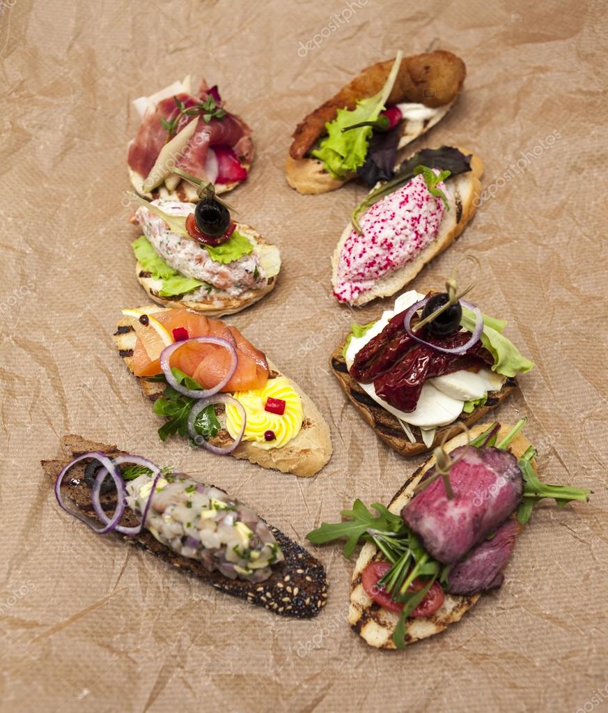 Set of Spanish tapas on the textiles background . Great background for ...