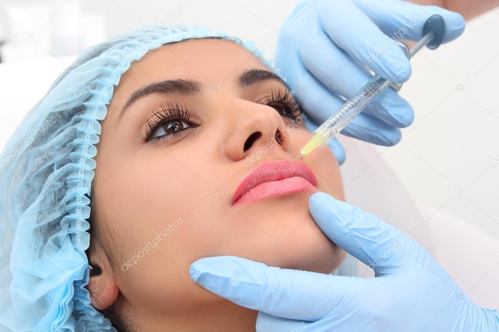 Beautiful woman gets an injection in her lips. — Stock Photo ...