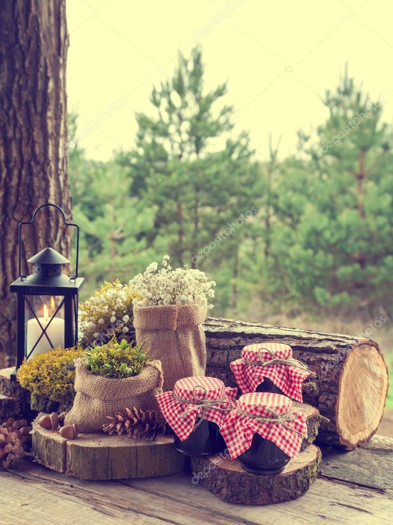 Wedding still life in rustic style: jars of fruit jam, vintage l ...